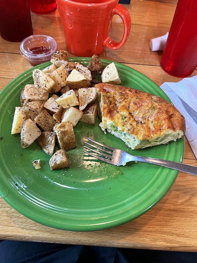 A perfectly executed quiche alongside seasoned potatoes—the breakfast of champions who don't need to run a marathon afterward.