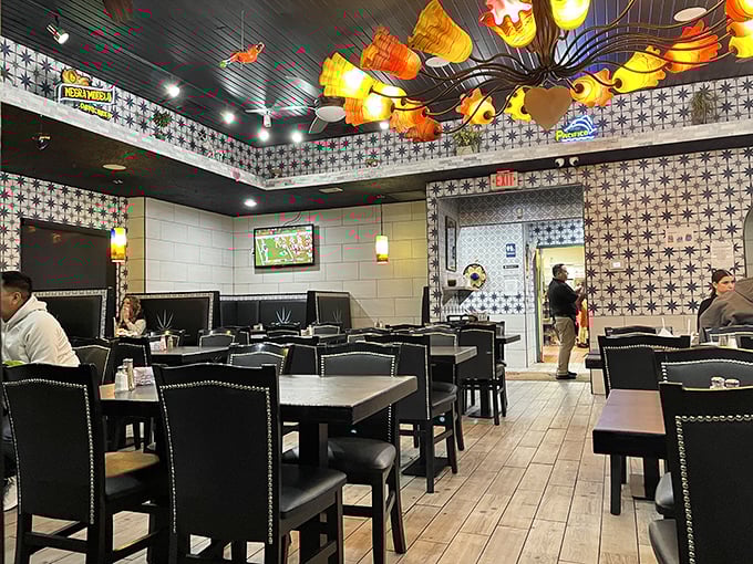 Dark ceilings, patterned tiles, and that spectacular light fixture—proving good design pairs with good food like lime with tequila.