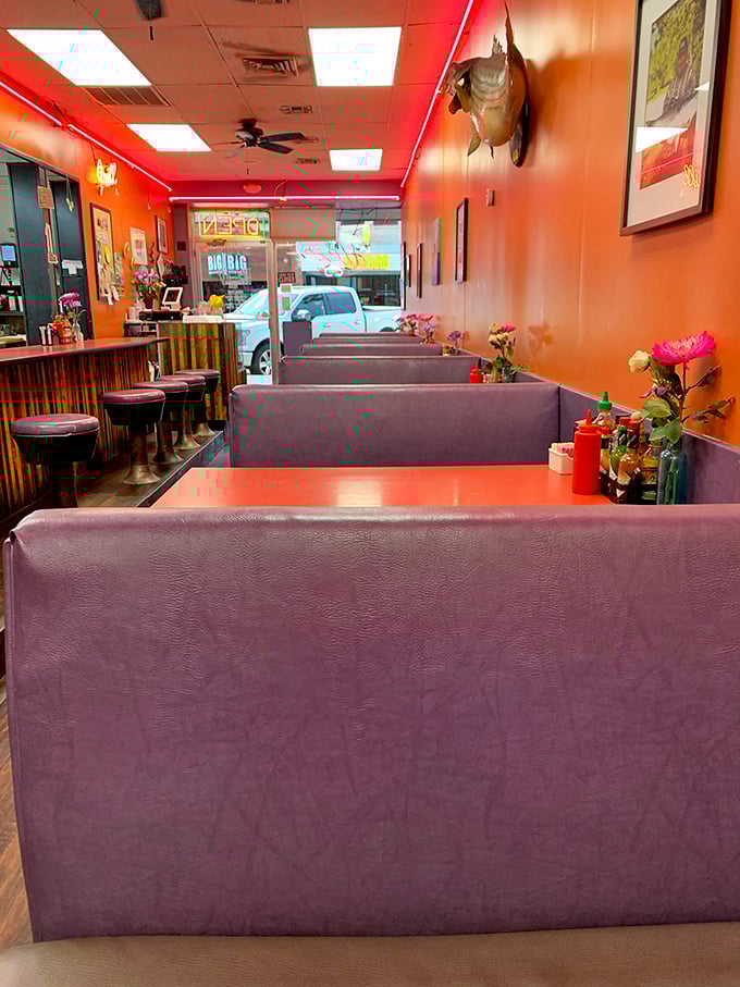 Purple booths and orange walls create a color scheme that shouldn't work but somehow feels like the exact right place to cure what ails you.