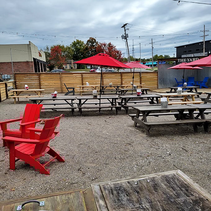 The outdoor dining area at Wright's offers picnic tables, red umbrellas, and the perfect setting for making important life decisions about sauce application.