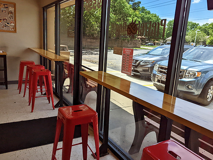 Window seating with cheerful red stools creates the perfect perch for pretzel consumption and people-watching. Simple pleasures done right.