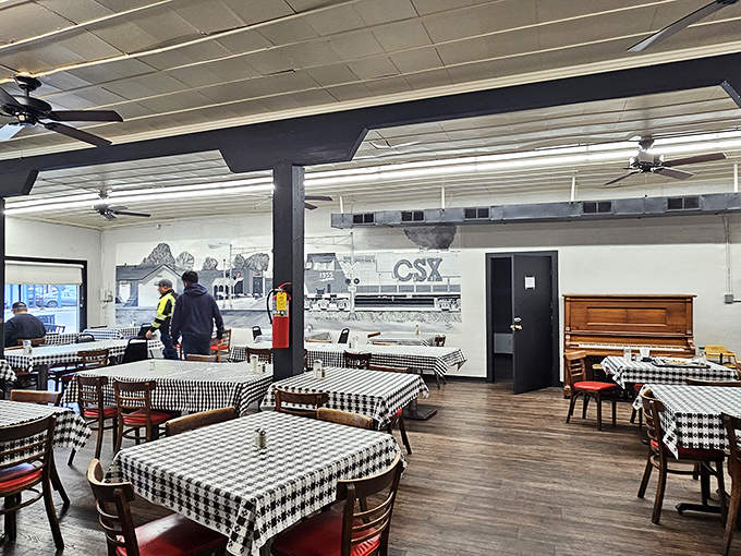 Not just tables and chairs – this is Tucker's living room, where black and white photographs tell stories while checkered tablecloths wait for yours.