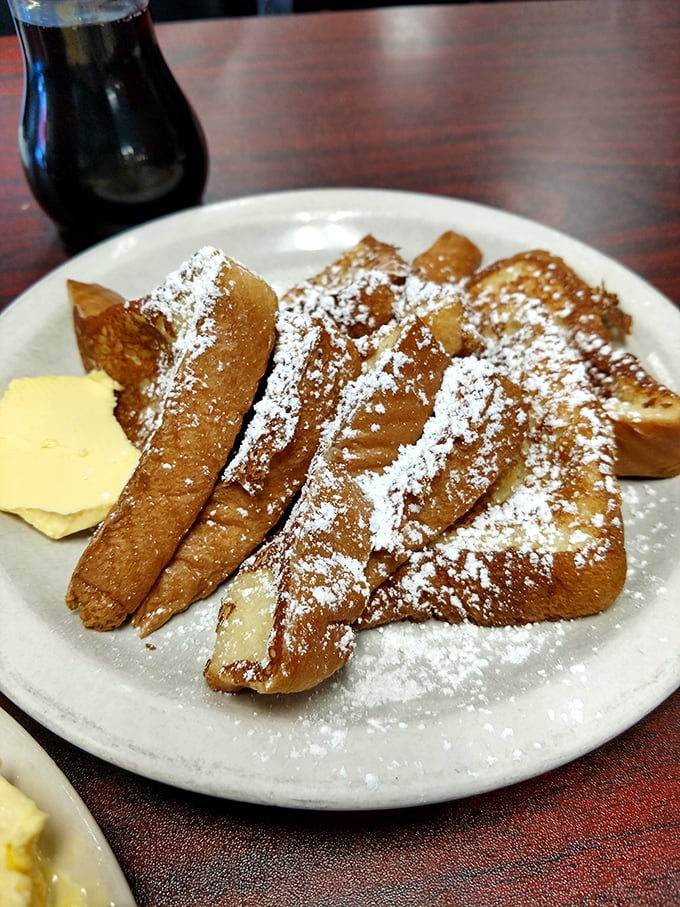 French toast that's been dipped, griddled, and dusted with powdered sugar – proof that bread can have a glorious second act.