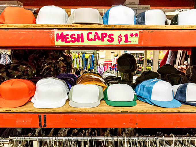 The hat wall: where $1 buys you both sun protection and style points. Mesh caps waiting to become someone's favorite headwear.