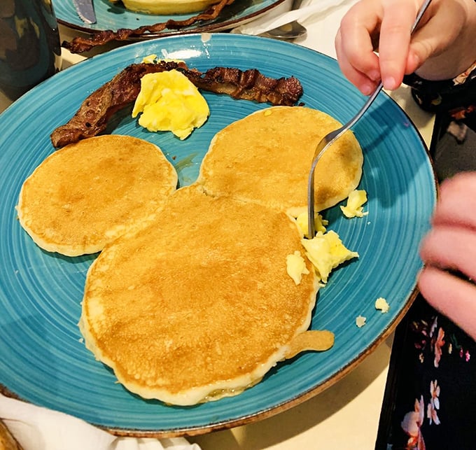 These pancakes have achieved that elusive golden glow that home cooks spend years trying to master. Breakfast sunshine on a blue plate.