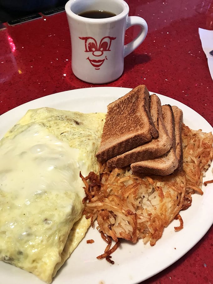 Breakfast architecture at its finest—marbled rye, golden eggs, and hash browns with ketchup artistry. A morning masterpiece on a plate.