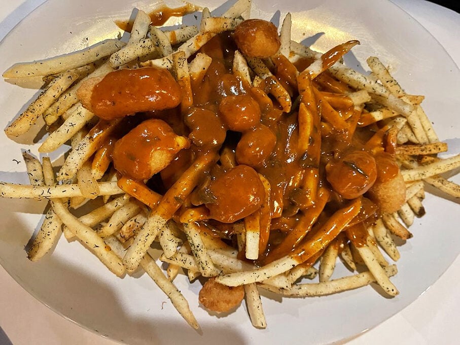 Crispy fries drowning happily in savory gravy. The kind of comfort food that makes you want to write a thank-you note to whoever invented it.