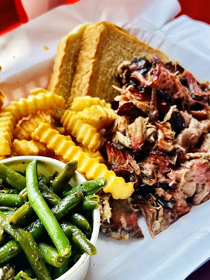 Pulled pork that actually tastes like pork, not just sauce – served with green beans that somehow avoid the "obligatory vegetable" category.
