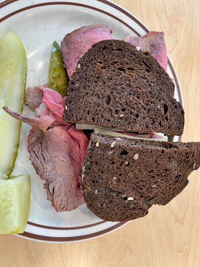 Dark rye bread, rosy roast beef, and a kosher dill pickle—a holy trinity of deli perfection that transcends religious boundaries.