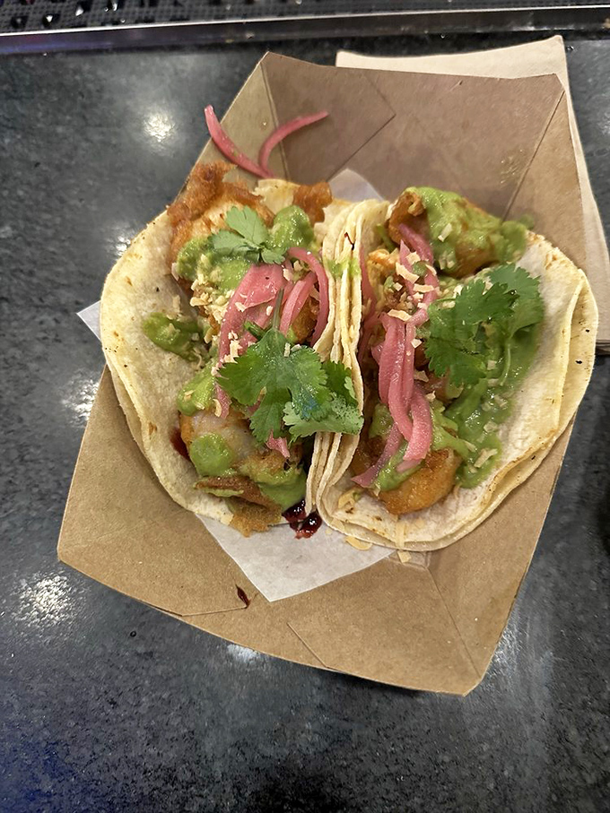 Tacos that look like they just stepped off a photo shoot. That orange sauce isn't just pretty—it's the flavor equivalent of finding an extra twenty in your pocket.