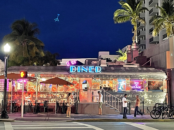 As night falls, the neon signs transform this roadside diner into South Beach's most honest late-night beacon for hungry night owls and early birds alike.