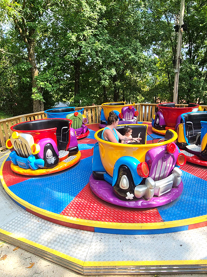 These technicolor teacups spin with the perfect combination of whimsy and mild vertigo—childhood joy distilled into carnival ride form.