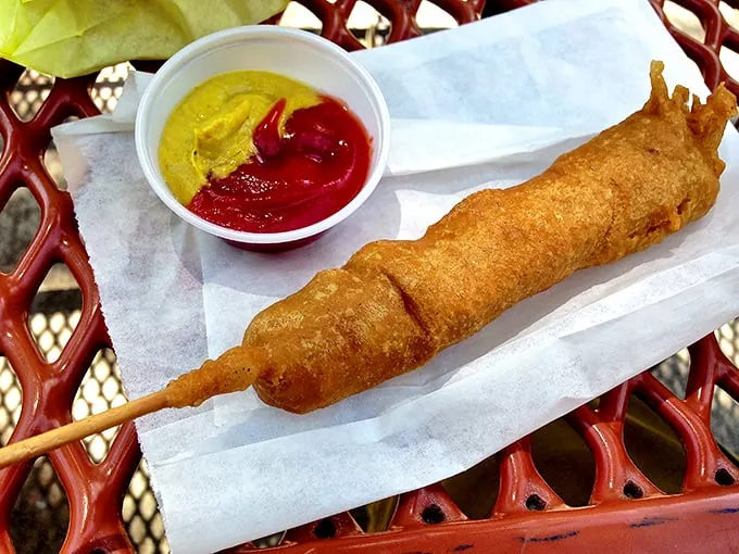 The corndog—America's contribution to food-on-a-stick technology—served with the timeless duo of ketchup and mustard for dipping pleasure.