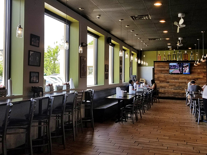 The dining area says "stay awhile" with its warm wood tones and mason jar lights – barbecue's natural habitat. 