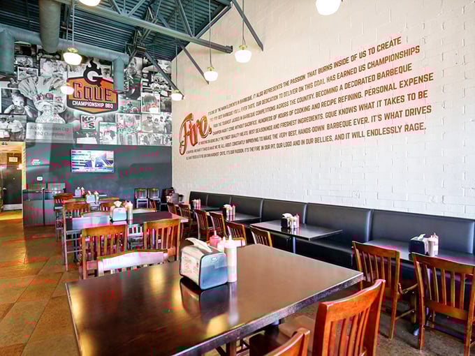 The dining room feels like barbecue's modern art gallery—clean lines, wood tables, and that fiery manifesto reminding you why you came.