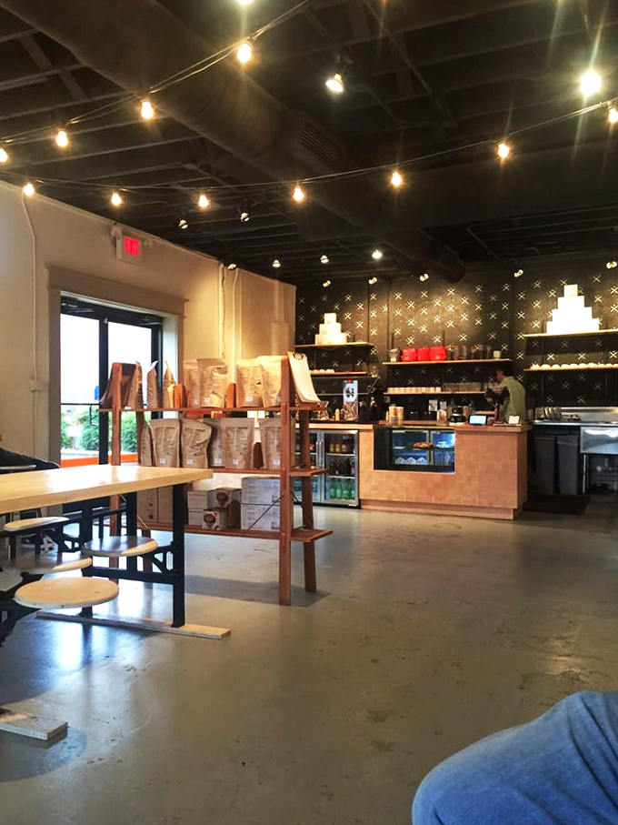 Industrial chic meets Memphis warmth—exposed ducts and concrete floors softened by wooden tables where coffee dreams and creative conversations unfold daily.