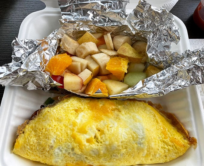 Breakfast to go isn't usually this photogenic. That omelet looks ready for its close-up, with fresh fruit playing a supporting role.