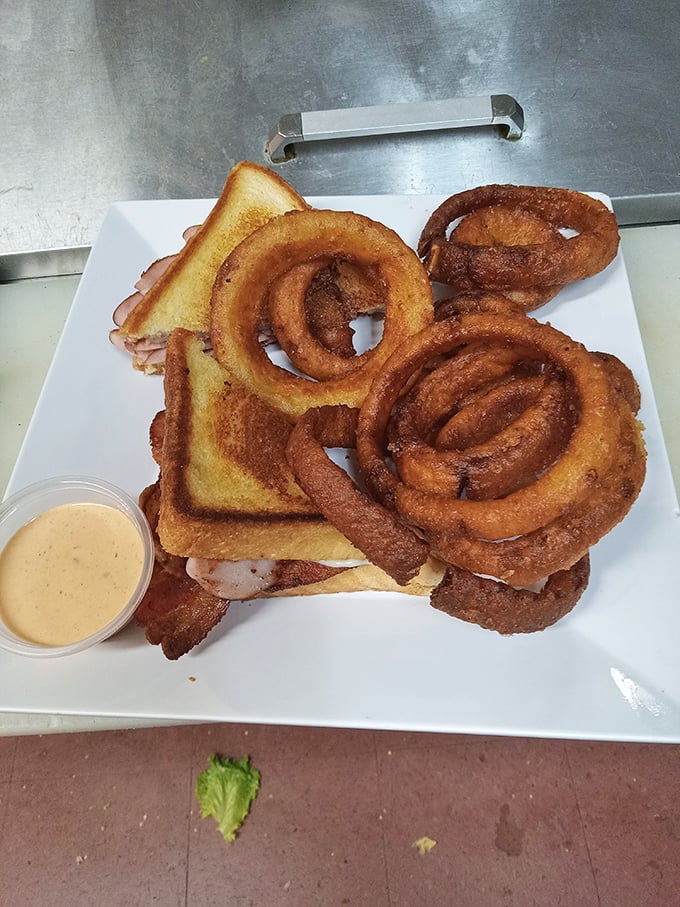 The sandwich that silences conversation. Those golden onion rings aren't a side—they're co-stars in this lunchtime drama of deliciousness.
