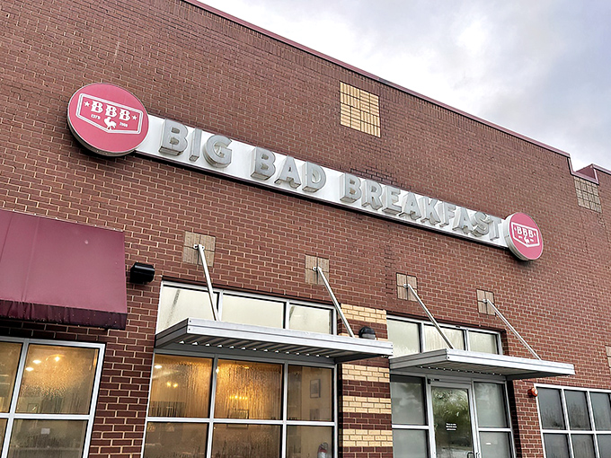The brick fortress of breakfast dreams announces itself with that bold red awning. Big Bad Breakfast isn't whispering its presence—it's shouting delicious promises.
