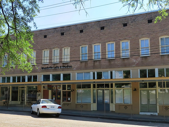 Woodville's historic Main Street welcomes visitors with its timeless charm, where brick buildings and covered walkways tell stories of Mississippi's past.
