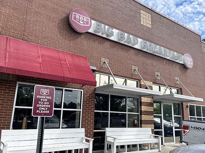 The brick fortress of breakfast dreams announces itself with that bold red awning. Big Bad Breakfast isn't whispering its presence—it's shouting delicious promises.