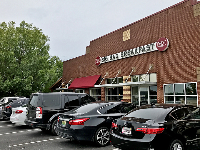 The brick fortress of breakfast dreams announces itself with that bold red awning. Big Bad Breakfast isn't whispering its presence—it's shouting delicious promises.