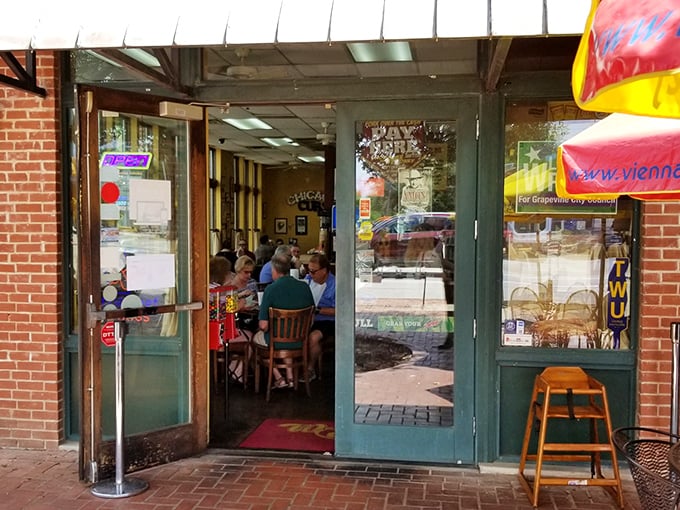 The brick exterior of Weinberger's Deli beckons with its understated charm. That yellow sign promises sandwich nirvana waiting just beyond those doors.
