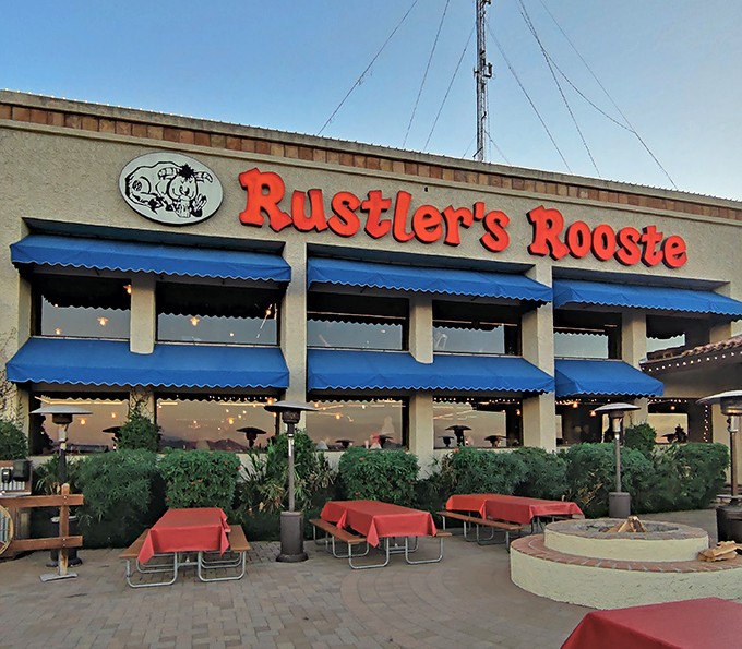 That sunset backdrop makes this Western steakhouse look like a movie set where cowboys actually eat well.