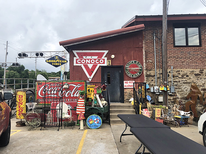 The iconic Conoco sign welcomes treasure hunters to this repurposed gas station, where seasonal decorations spill onto the porch like a festive welcome committee.