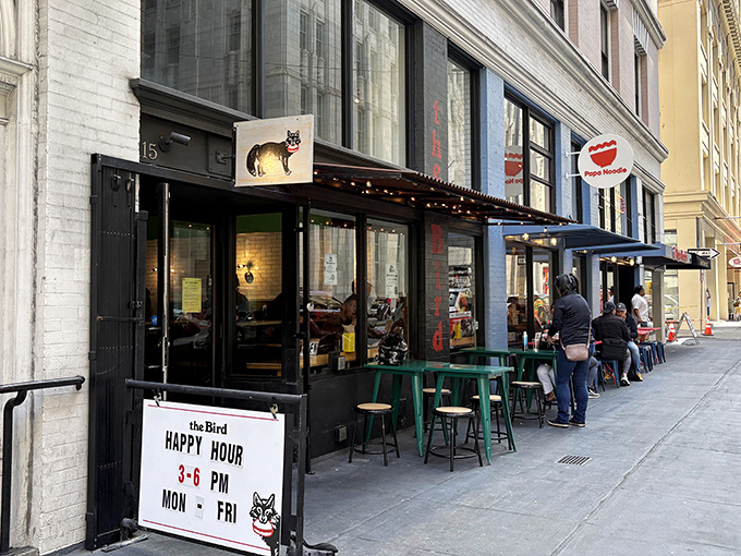 The bold red letters against the black storefront announce "the Bird" with no fanfare - just a promise of poultry perfection waiting inside.