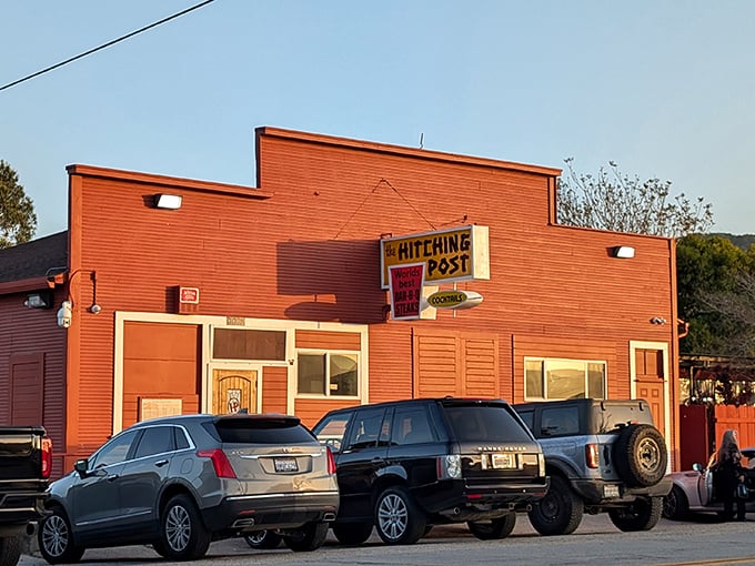 The iconic red exterior of Hitching Post is like a beacon to steak lovers, promising smoky, oak-grilled perfection inside this Casmalia landmark.