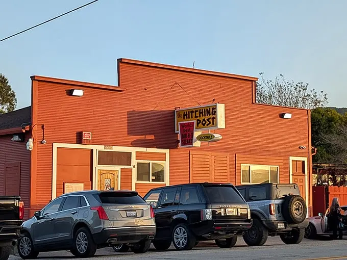 The iconic red exterior of Hitching Post is like a beacon to steak lovers, promising smoky, oak-grilled perfection inside this Casmalia landmark.