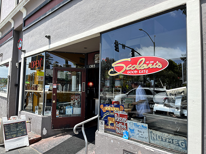 The unassuming storefront of Scolari's Good Eats beckons with its red neon "OPEN" sign—like a lighthouse guiding hungry sailors to delicious shores.