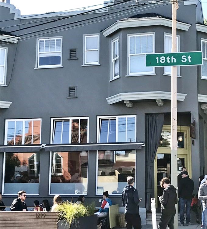 That iconic yellow door isn't just an entrance—it's a portal to pancake paradise in San Francisco's Inner Sunset neighborhood.