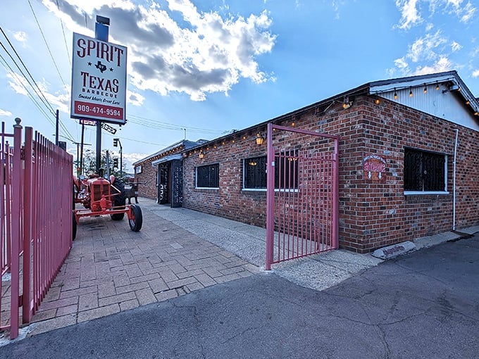 The brick exterior of Spirit of Texas BBQ stands like a meaty embassy on California soil, promising authentic Lone Star flavors under clear blue skies.