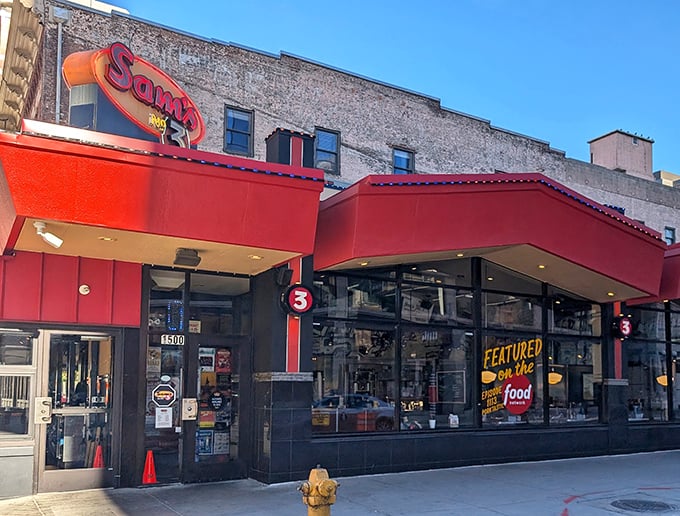 The neon glow of Sam's No. 3 against Denver's skyline isn't just a sign—it's a beacon of culinary comfort calling hungry souls home.