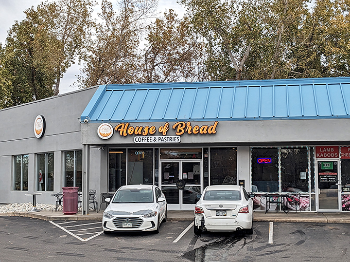 The blue-roofed sanctuary of carbs announces itself with golden lettering that practically whispers, "Yes, this is where the good stuff lives."