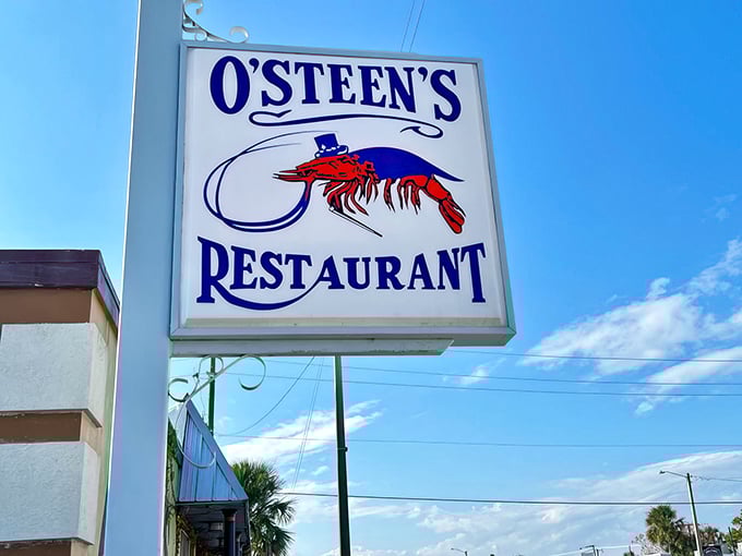 The unassuming exterior of O'Steen's, where that wooden bench isn't just seating—it's the waiting room for some of Florida's finest seafood.