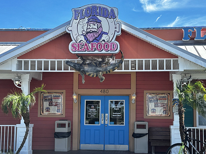 The coral-colored exterior with bright blue doors isn't just eye-catching—it's practically shouting "Fresh seafood inside!" like a friendly maritime beacon.