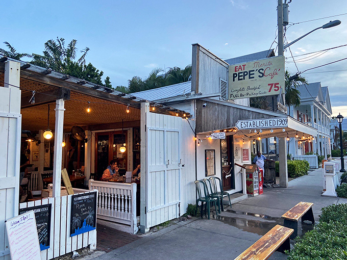 The white picket fence and vintage lamp post aren't just charming decor—they're time machines to Old Florida, where bicycles outnumber BMWs.