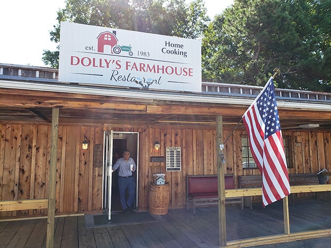 The rustic wooden exterior of Dolly's Farmhouse Restaurant promises authenticity before you even step inside. That American flag isn't just decoration—it's a guarantee.