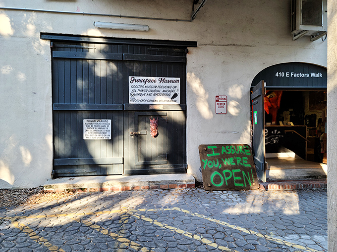 The unassuming entrance to Graveface Museum could easily be mistaken for a speakeasy or secret society headquarters. That handwritten "WE'RE OPEN" sign? Pure invitation to curiosity.
