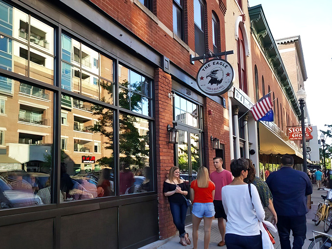 The Eagle's brick exterior on Mass Ave beckons hungry patrons like a siren song. That line forming outside? Consider it a preview of deliciousness to come.