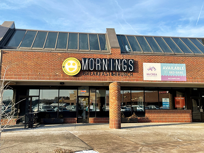 The cheerful yellow smiley face logo seems to know something you don't yet—that breakfast nirvana awaits behind those brick walls.