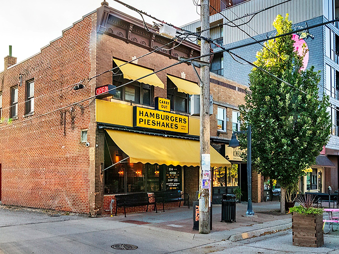 The iconic yellow awning of Hamburg Inn No. 2 beckons like a breakfast lighthouse on Linn Street, promising pieshakes and happiness since 1948.