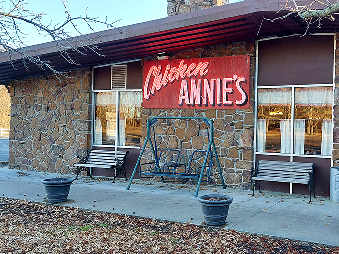 The stone facade and iconic red sign of Chicken Annie's Original stands as a monument to fried chicken perfection in Pittsburg, Kansas.