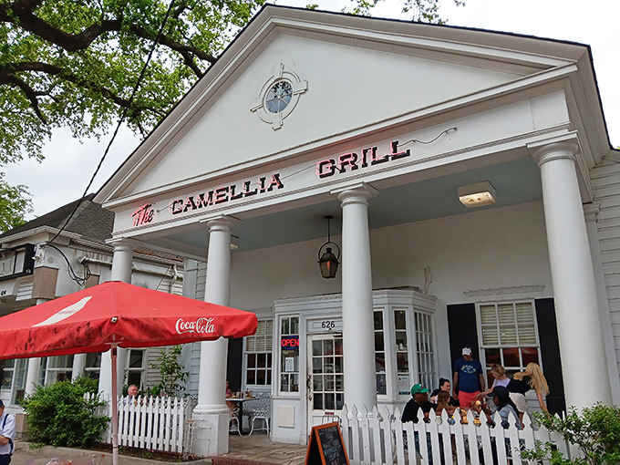 A Greek revival facade that houses burgers instead of philosophy—The Camellia Grill's columned entrance promises Southern hospitality with a side of architectural charm.