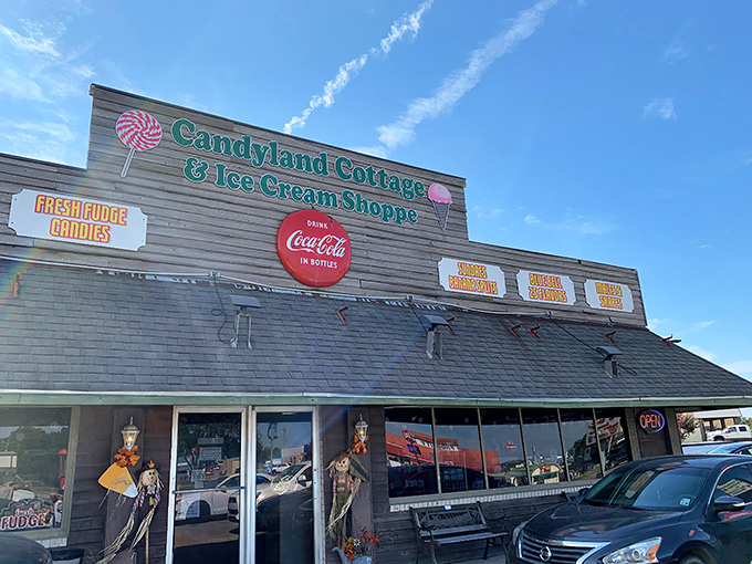 The charming exterior of Candyland Cottage beckons like a sweet mirage in Rayne, promising sugar-fueled nostalgia behind those vintage windows.