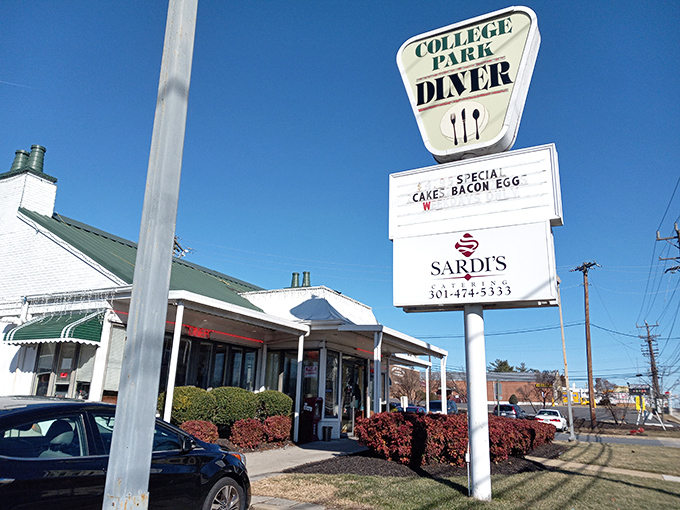 The classic roadside sign beckons like an old friend, promising salvation for empty stomachs and the certainty that proper breakfast is just steps away.