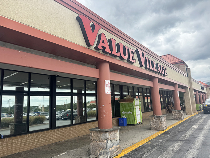 The iconic red Value Village sign welcomes treasure hunters to this suburban Maryland thrift mecca, where bargains await behind those unassuming glass doors.